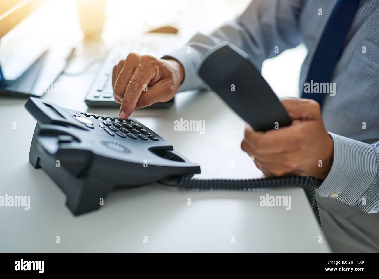 Hes ready to assist. an unrecognizable businessman dialing a number on ...