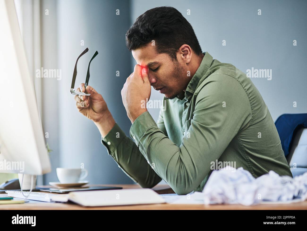 I need to take something for this splitting headache. a uncomfortable young businessman holding ...