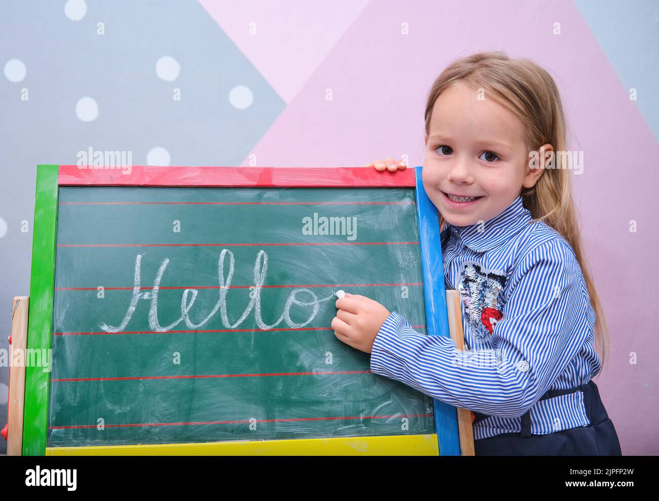 Adorable happy little girl stand blackboard Homeschooling write chalk ...