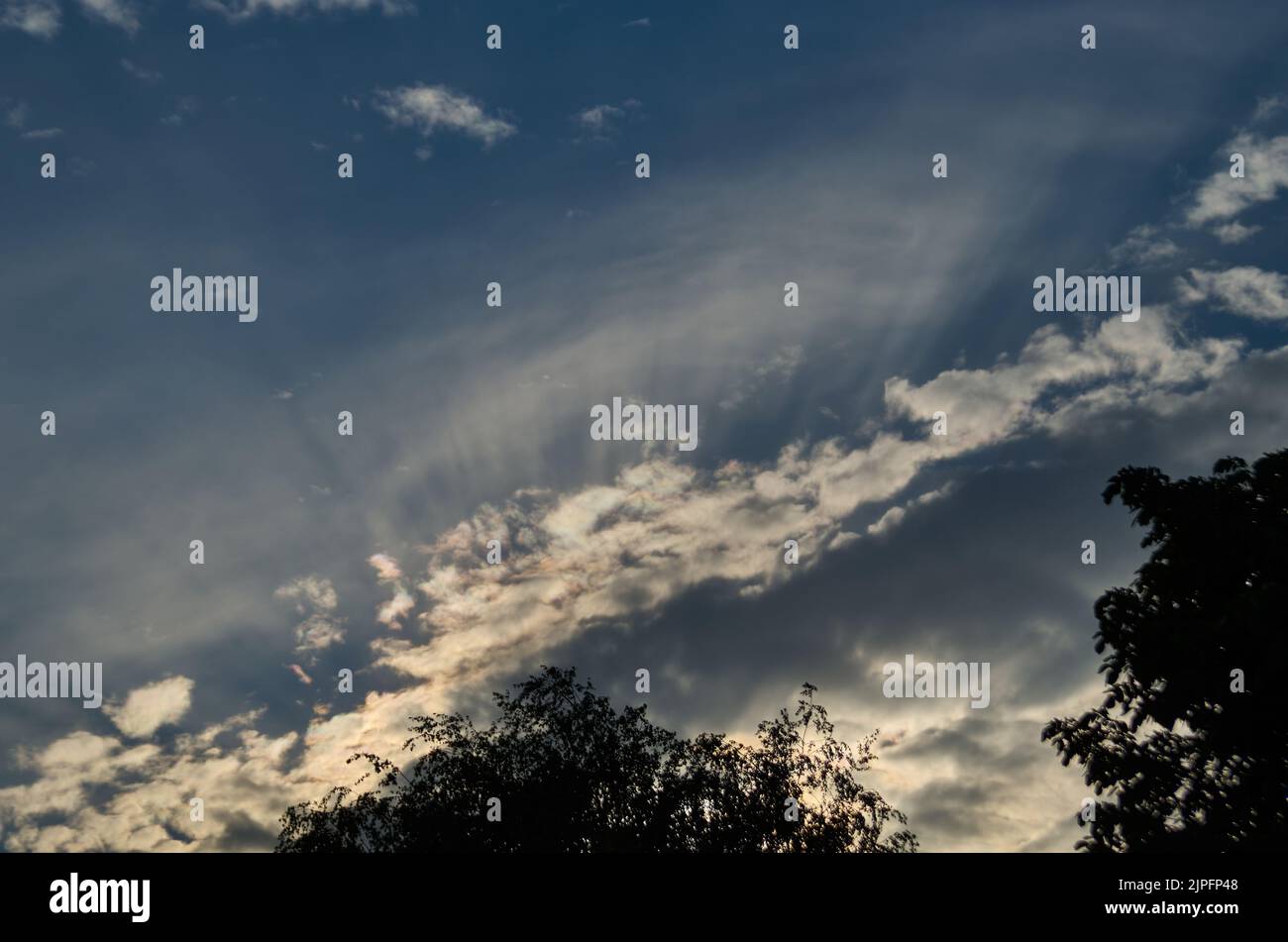 Colorful dramatic sky with dark clouds and sunbeam Stock Photo - Alamy