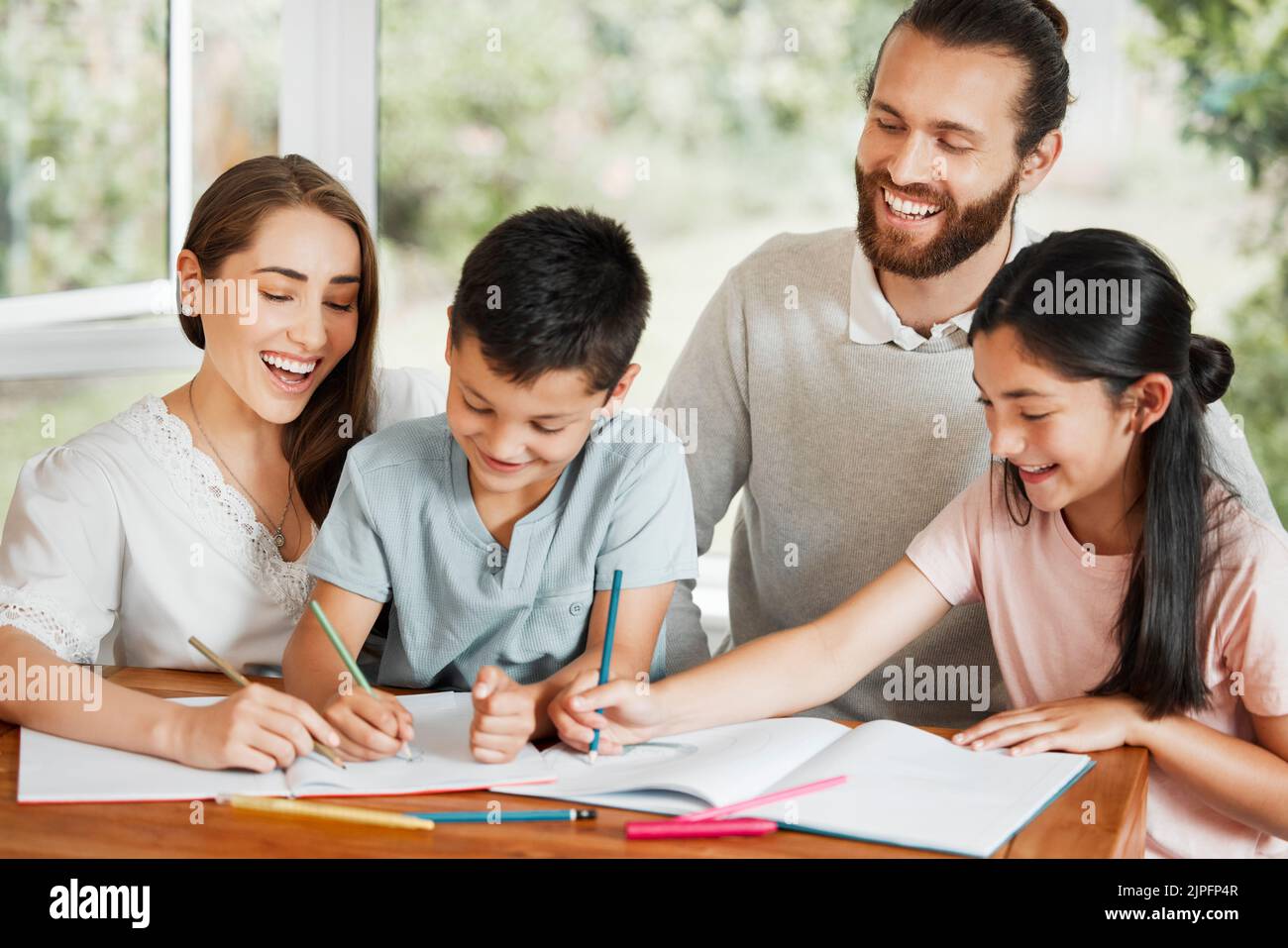 Learning, education and homework with a family writing, drawing and ...