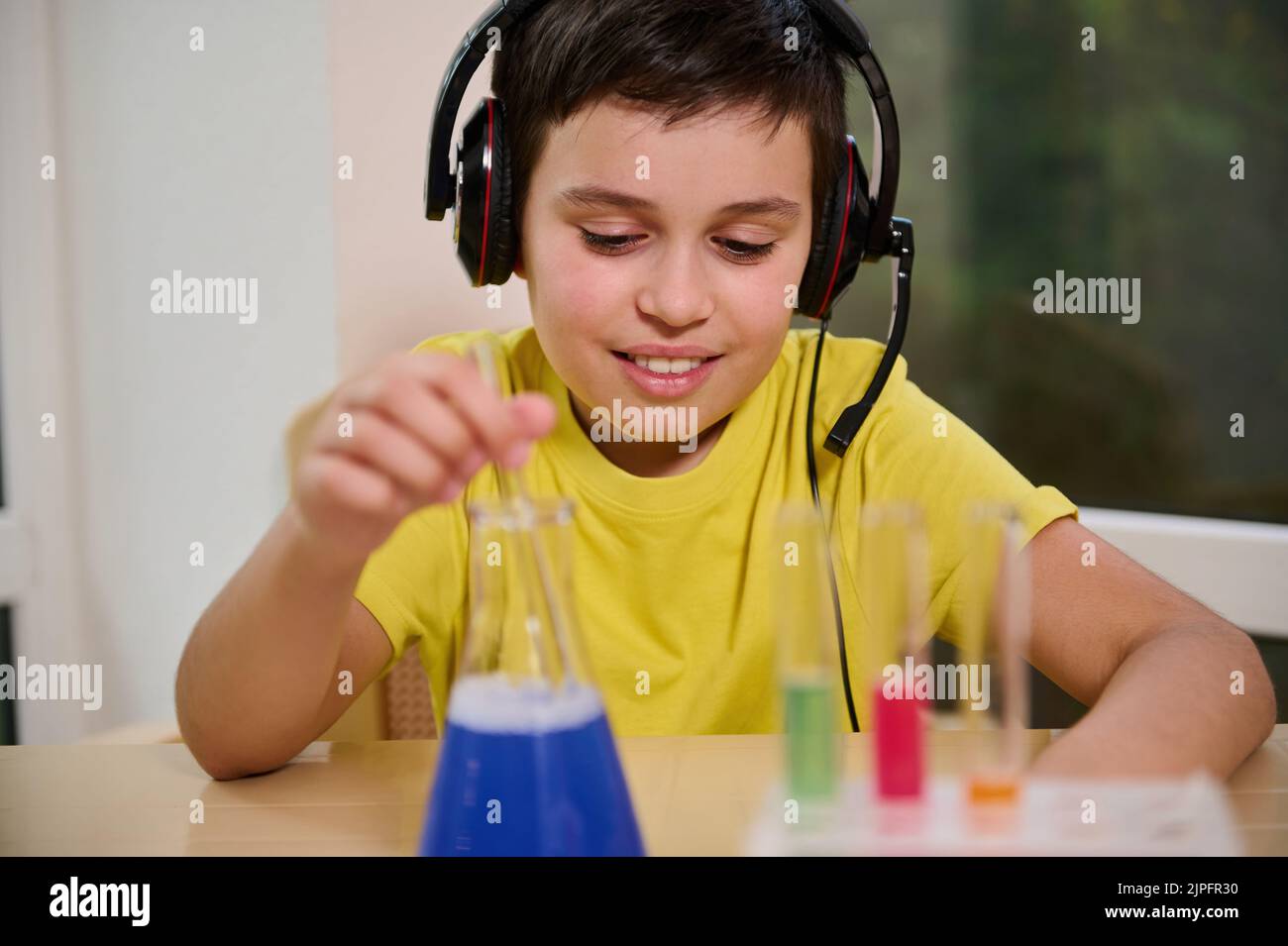 Close-up of an excited teenage student doing a chemistry experiment in ...