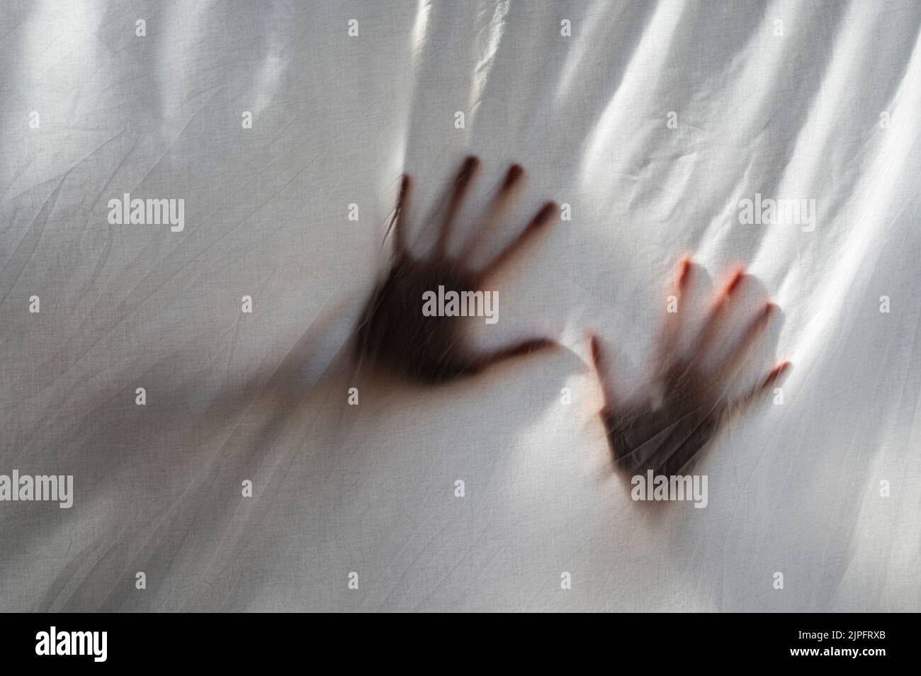 Hands shade behind sheet Stock Photo - Alamy