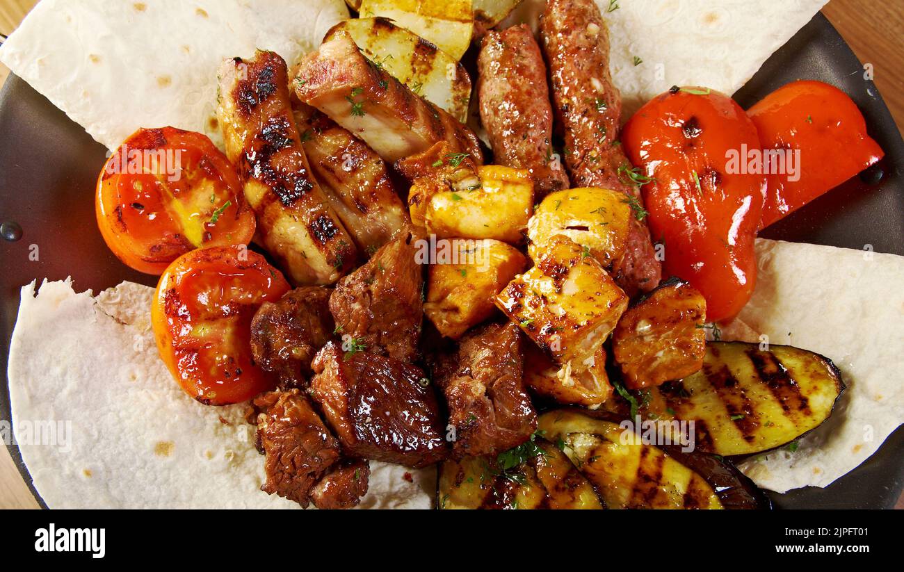 Azerbaijani sac, meal with grilled eggplant, potato slices, beef ...