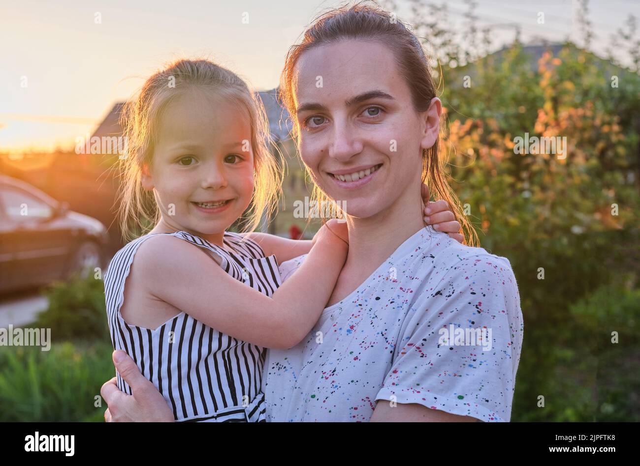 portrait happy mother holding Cute young daughter smiling sunlight home outdoor Stock Photo - Alamy