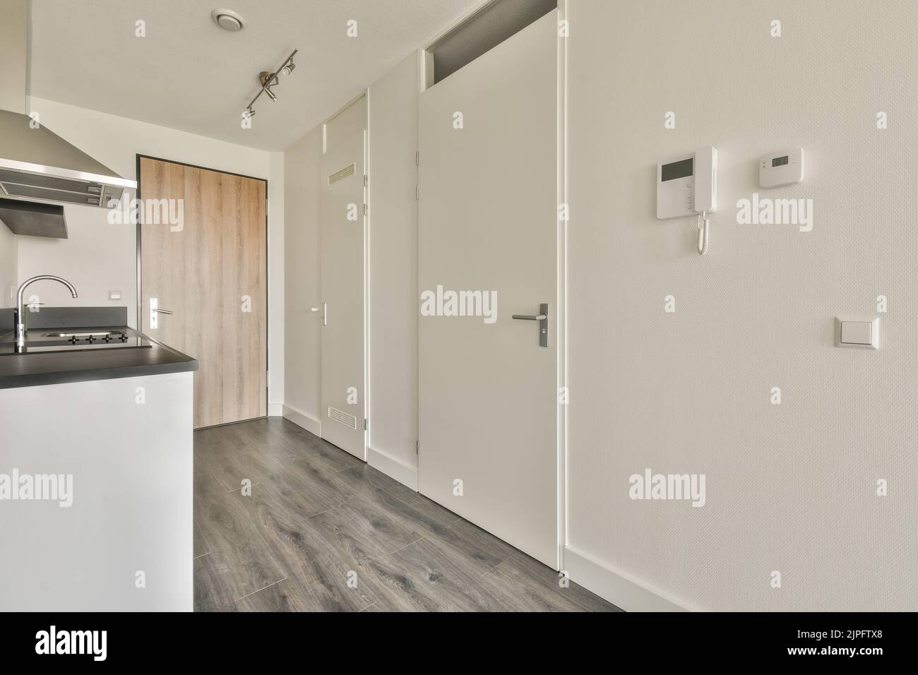 Interior of empty white kitchen with windows and wooden parquet floor ...