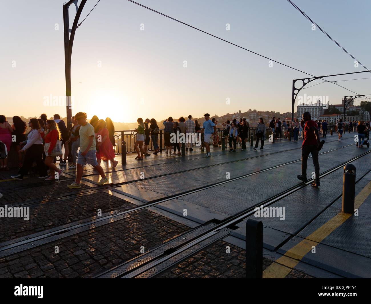 People walking along the Luis I bridge and admiring the view in Porto ...