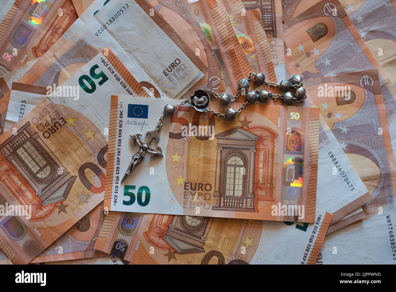 Catholic gothic cross on a background of money Stock Photo - Alamy