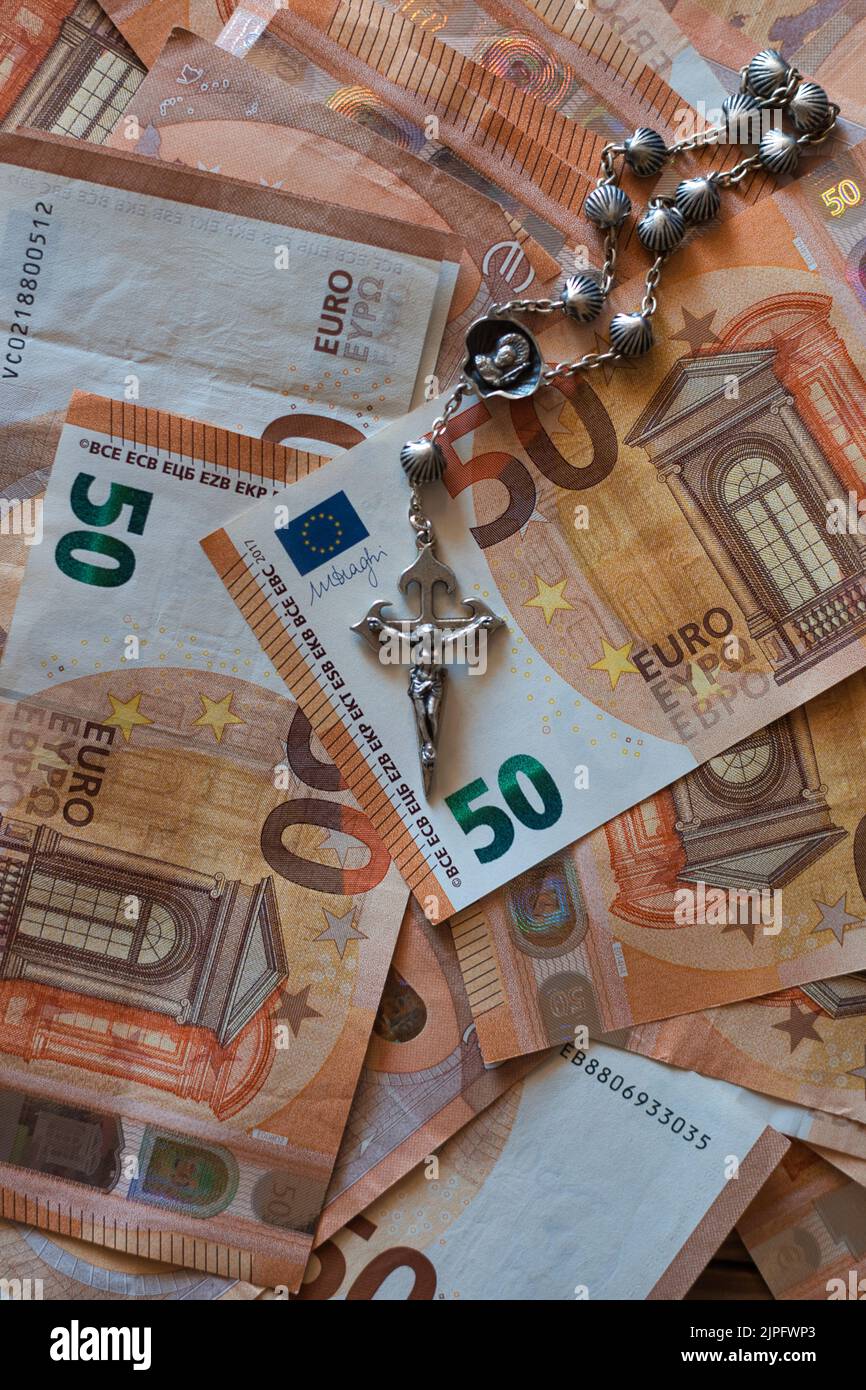 Catholic gothic cross on a background of money Stock Photo - Alamy