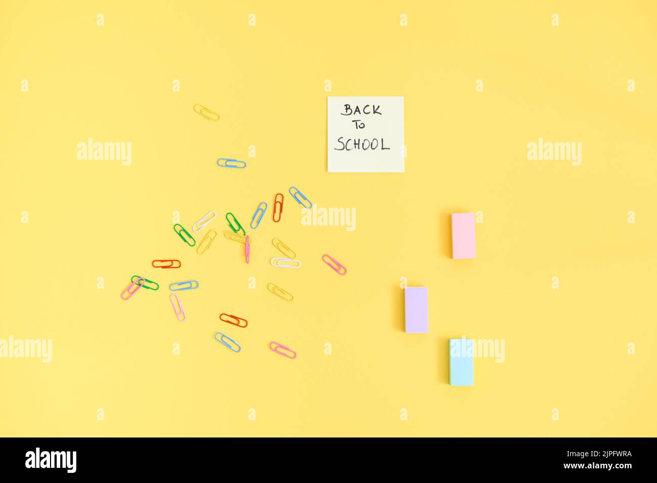 colorful clips with back to school sticky note on yellow background ...