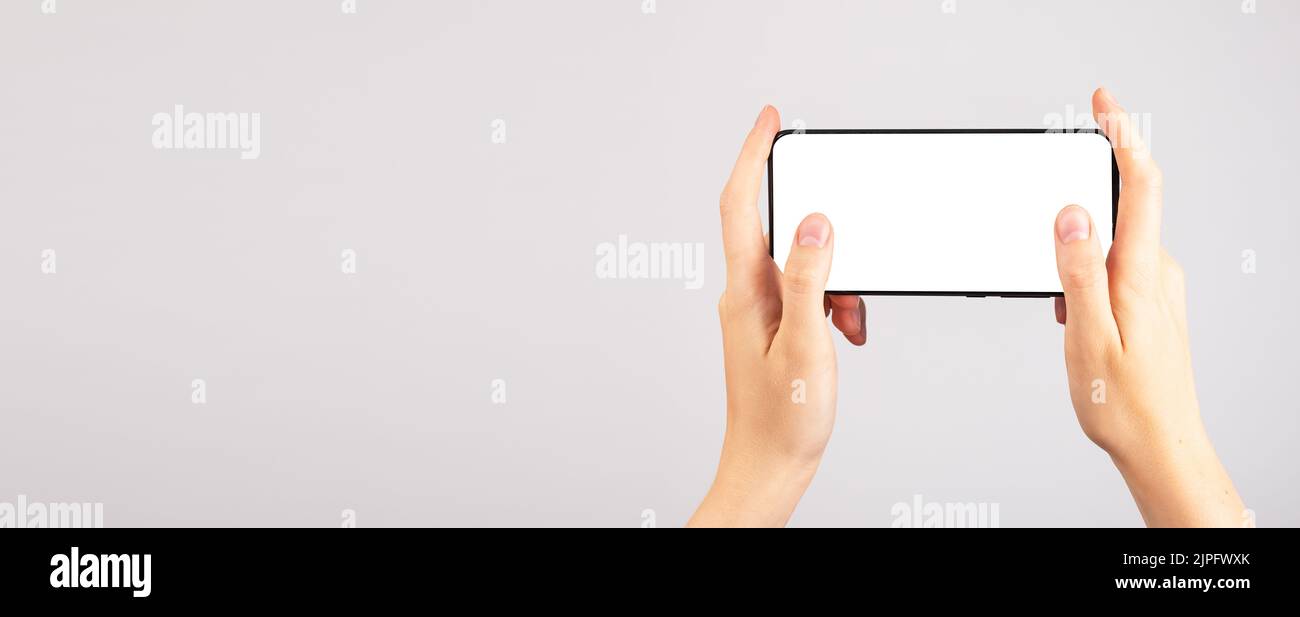 Banner with hands holding phone mockup in horizontal position. Woman ...