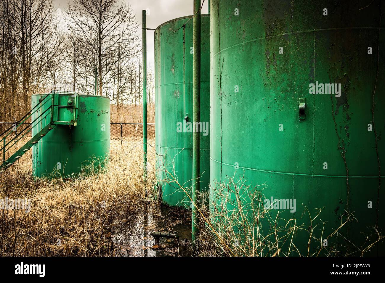 Two green tanks full of natural gas in a field during the day Stock ...