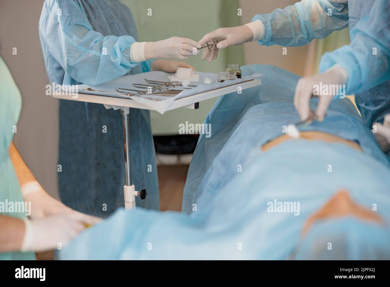 Surgeon in operation with instruments hi-res stock photography and ...