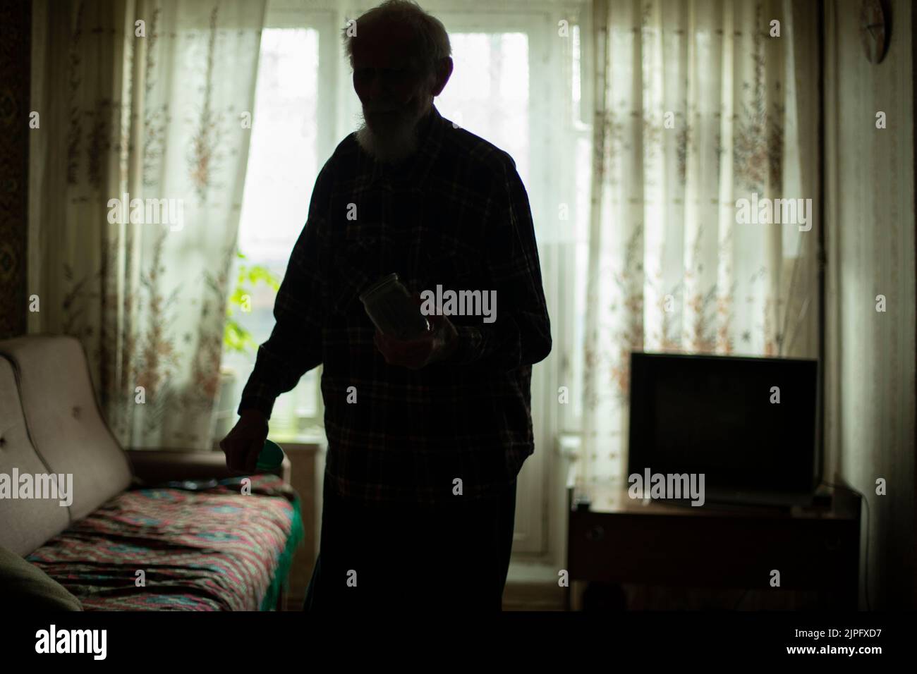 Old man in room. Grandfather in old apartment. Pensioner in Russia ...