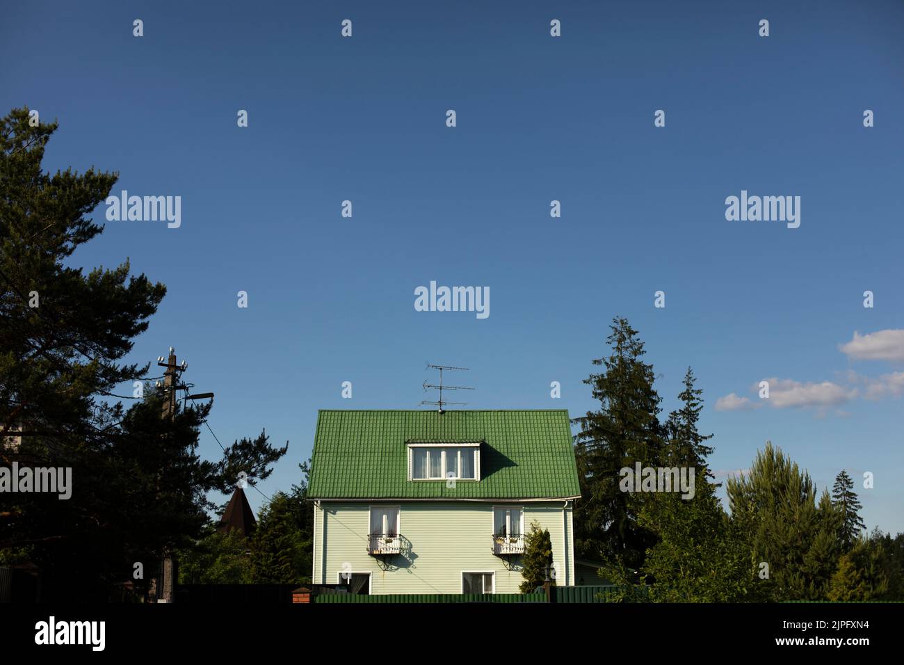 House with green roof in countryside. Country house in forest ...