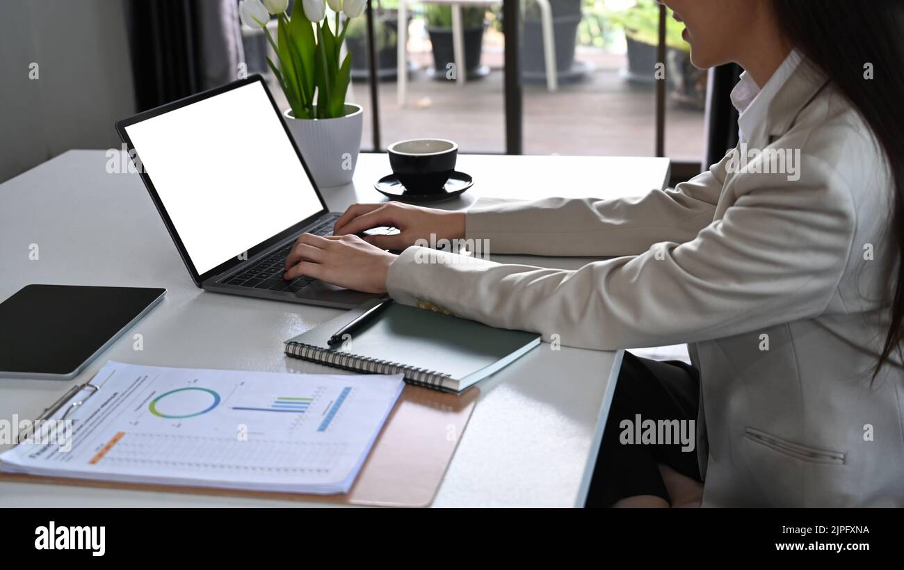 Female accountant checking financial reports and using calculator to ...