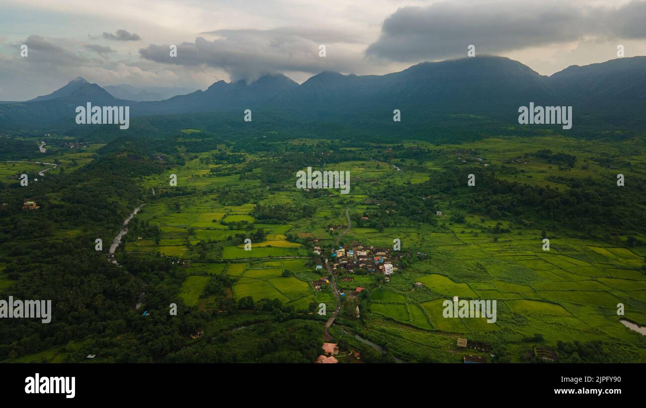 An aerial view of beautiful green land and the mountains in the ...