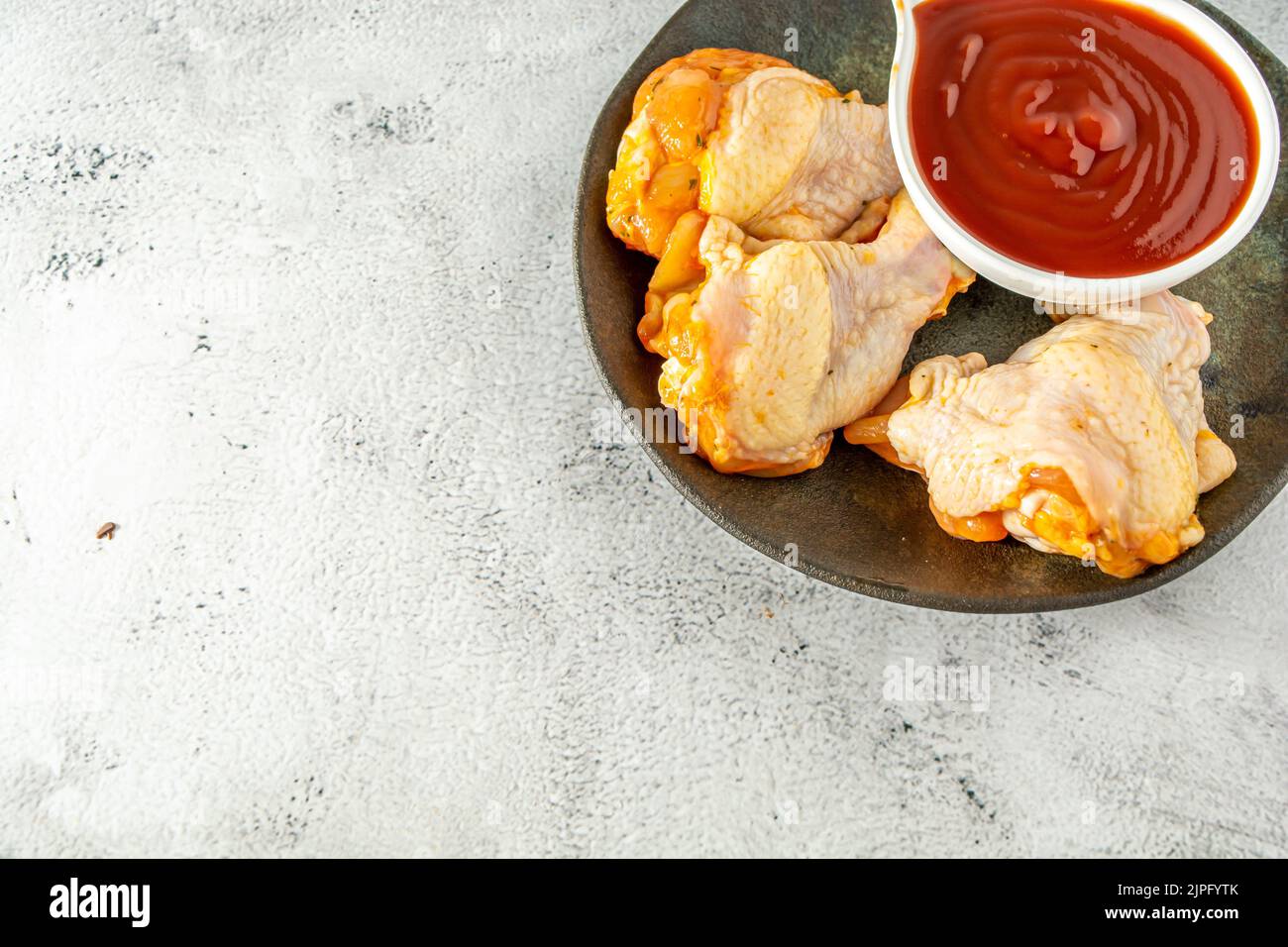 chicken drumstick and sauce, high angle top view Stock Photo - Alamy