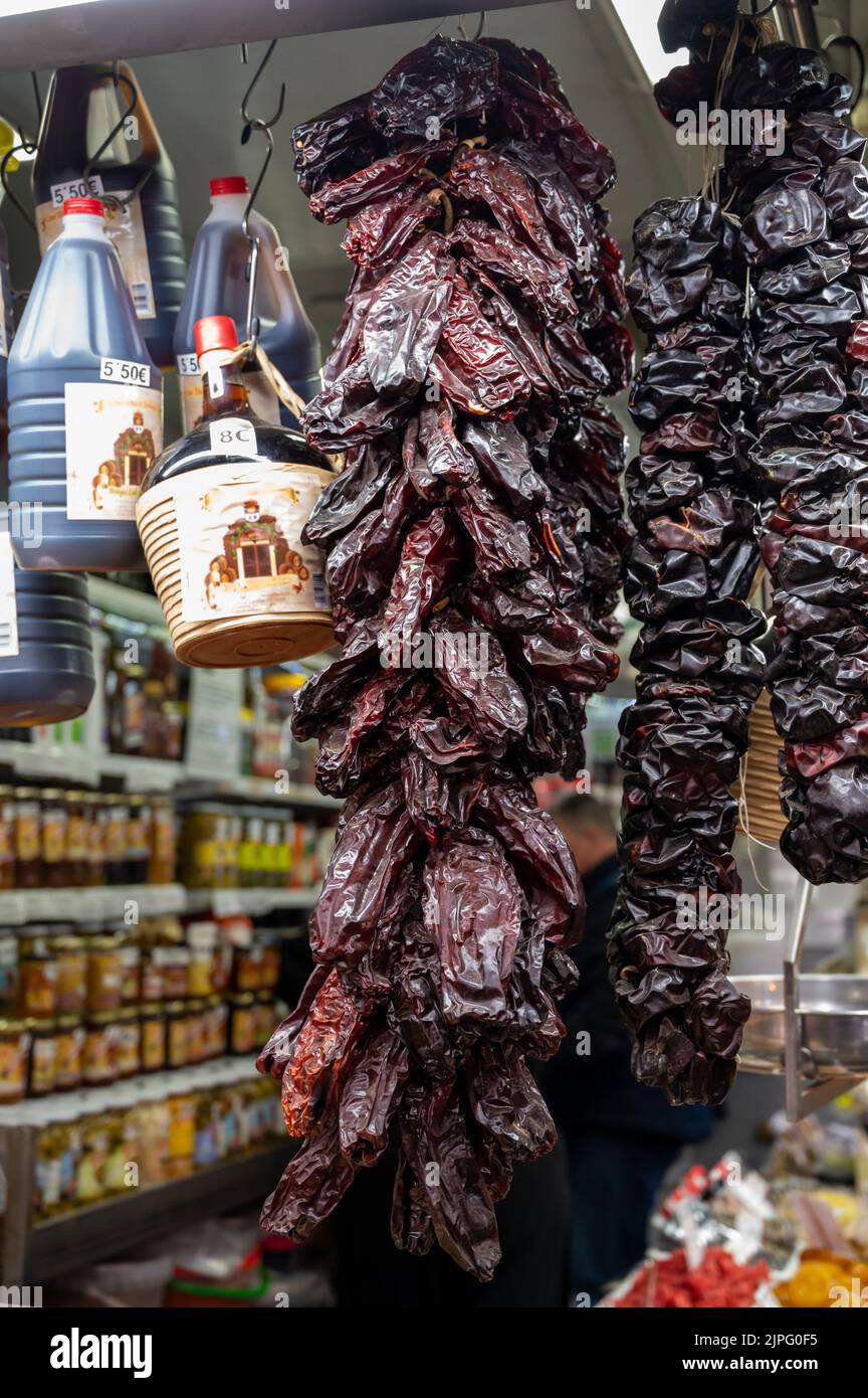 Bunch of dried pimento paprika hanging on farmers market in Spain Stock ...