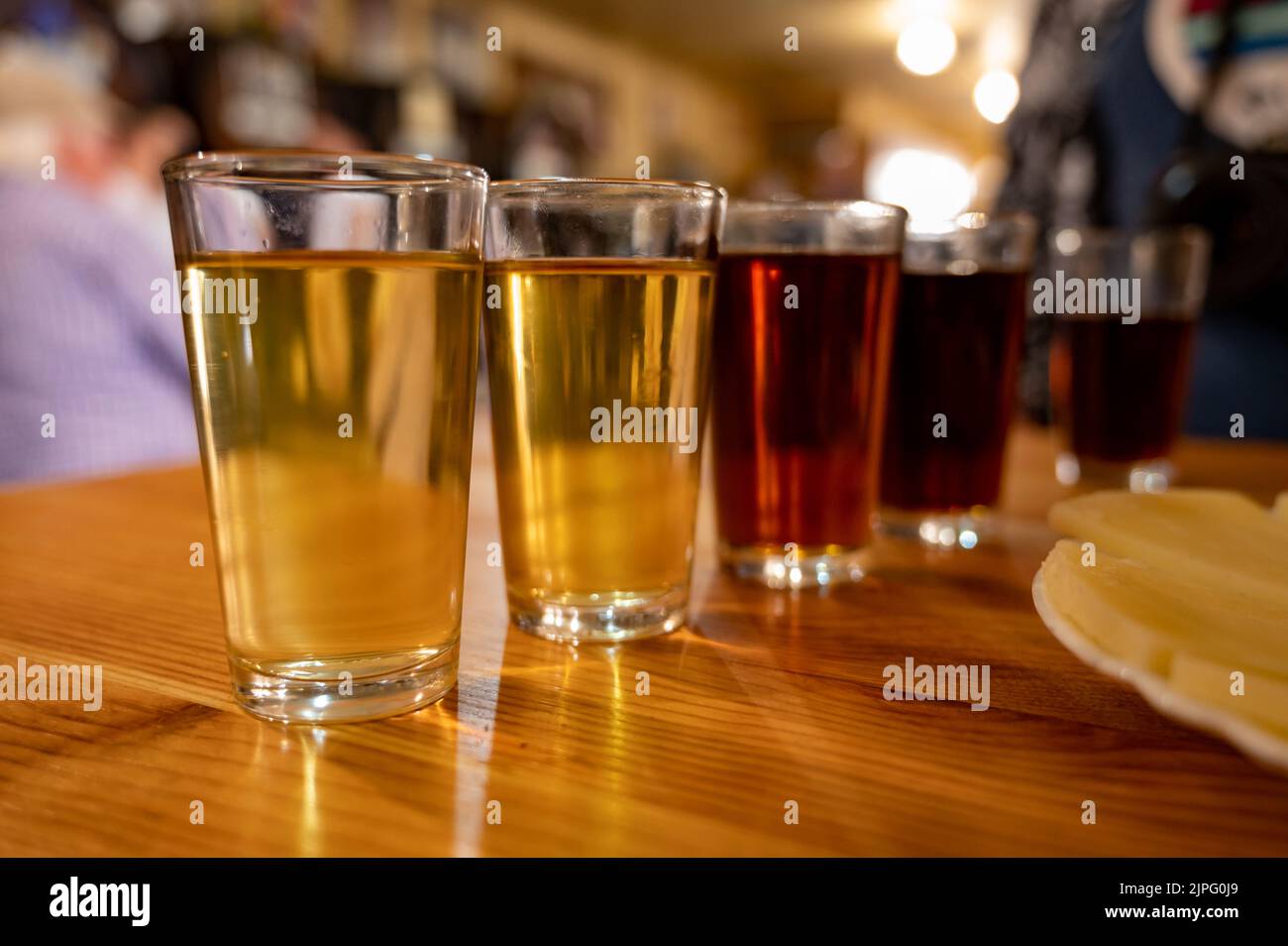 Tasting of different sweet wines from wooden barrels on old bodega wine ...