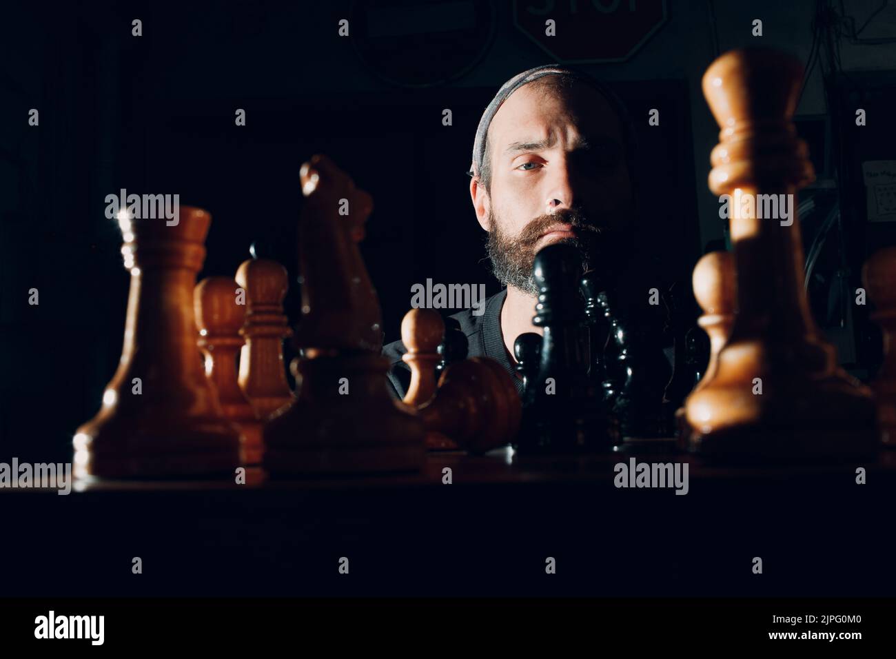 Young adult man play chess in dark Stock Photo - Alamy