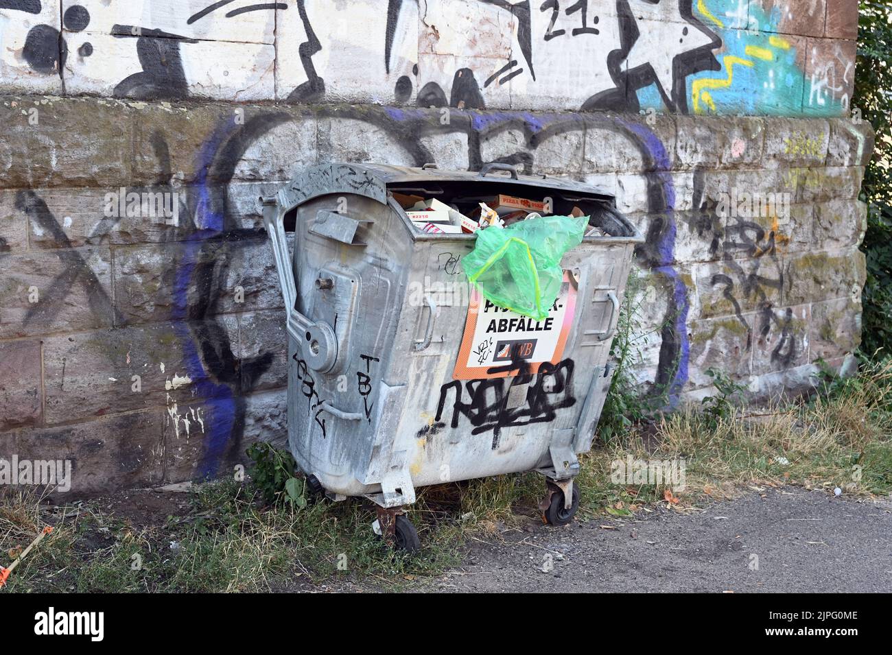 Cologne, Germany. 13th Aug, 2022. Full dumpster with pizza boxes stands ...