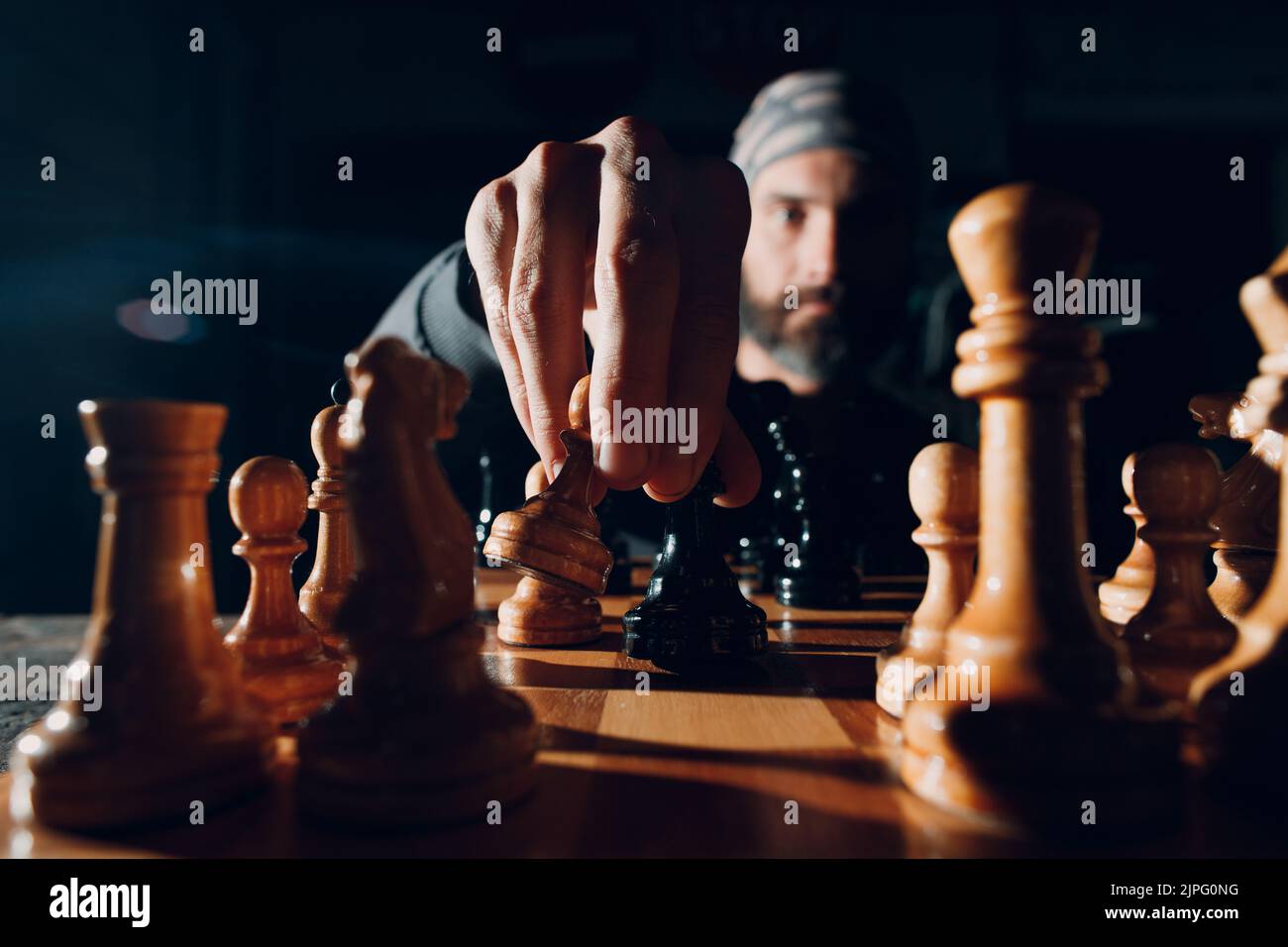 Young adult man play chess in dark Stock Photo - Alamy