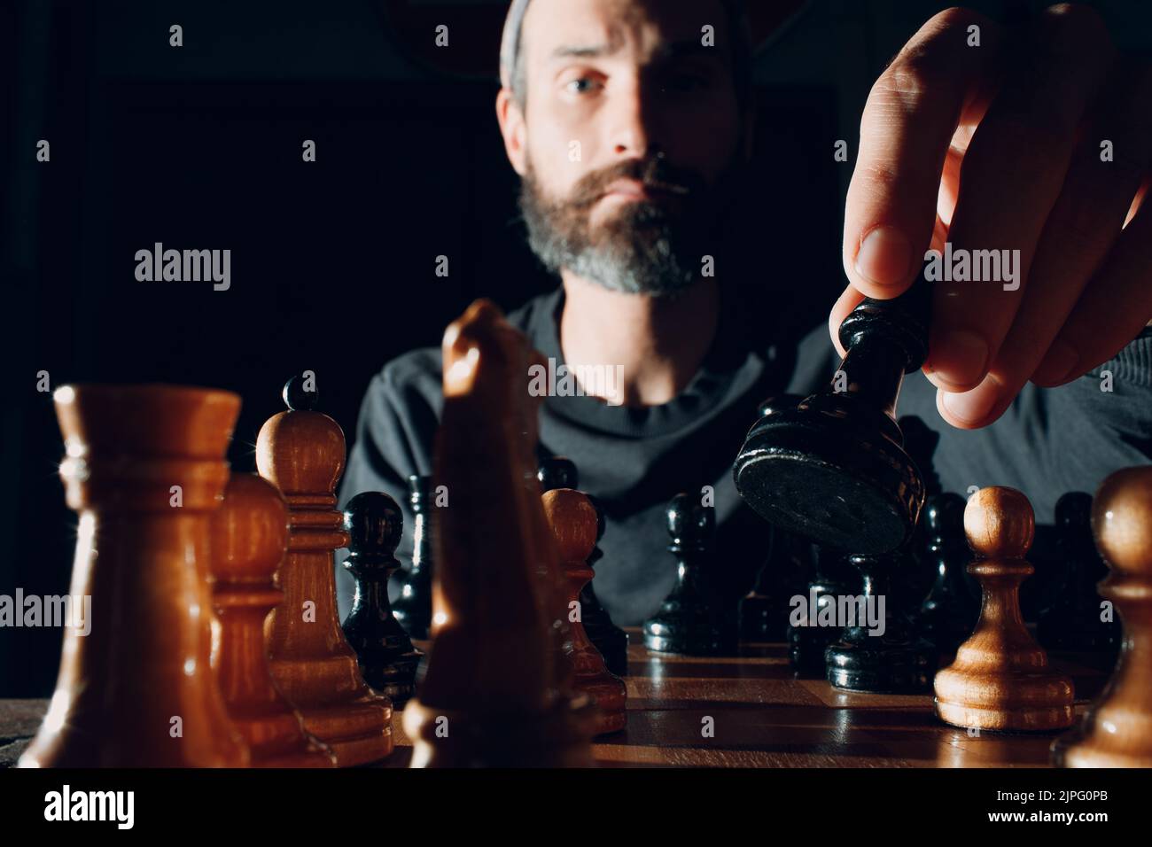 Young adult man play chess in dark Stock Photo - Alamy