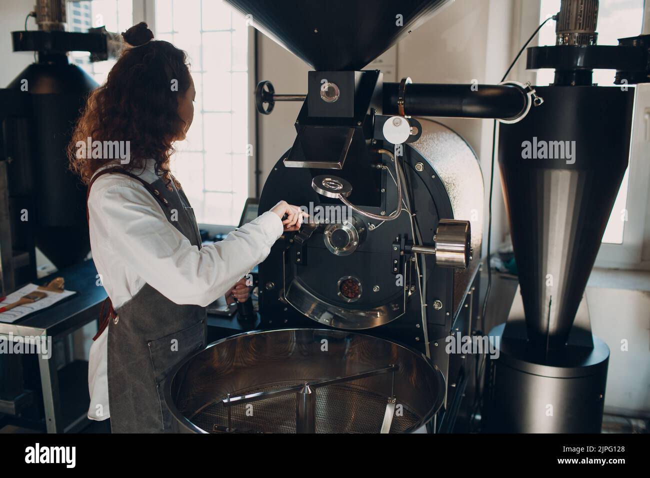Coffee roaster machine and barista with tryer at coffee roasting ...