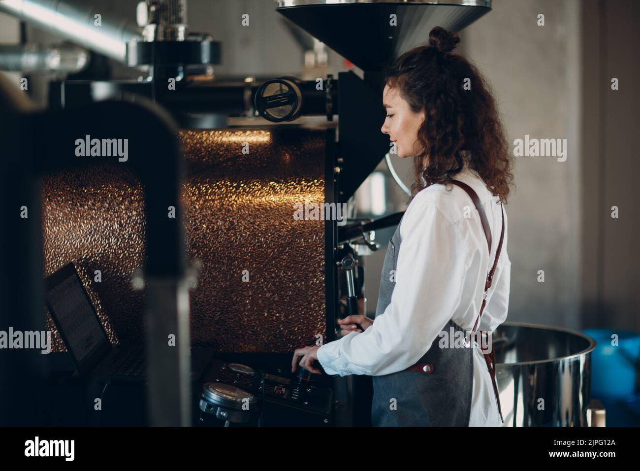Coffee roaster machine and barista woman control coffee roasting ...
