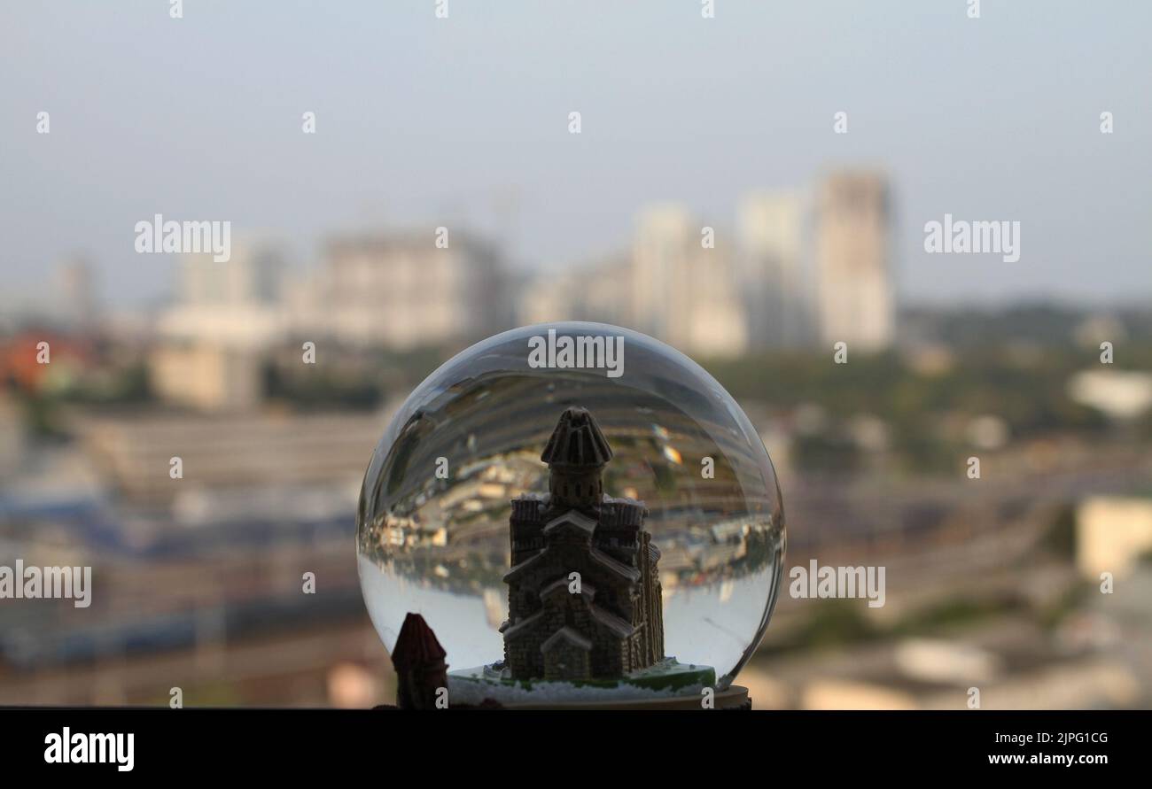 Toy tower in crystal glass ball with real cityscape soft focus Stock ...