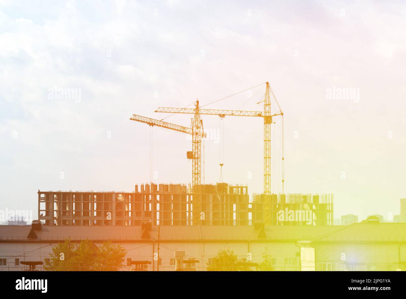 Construction cranes, construction site. The house is under construction ...