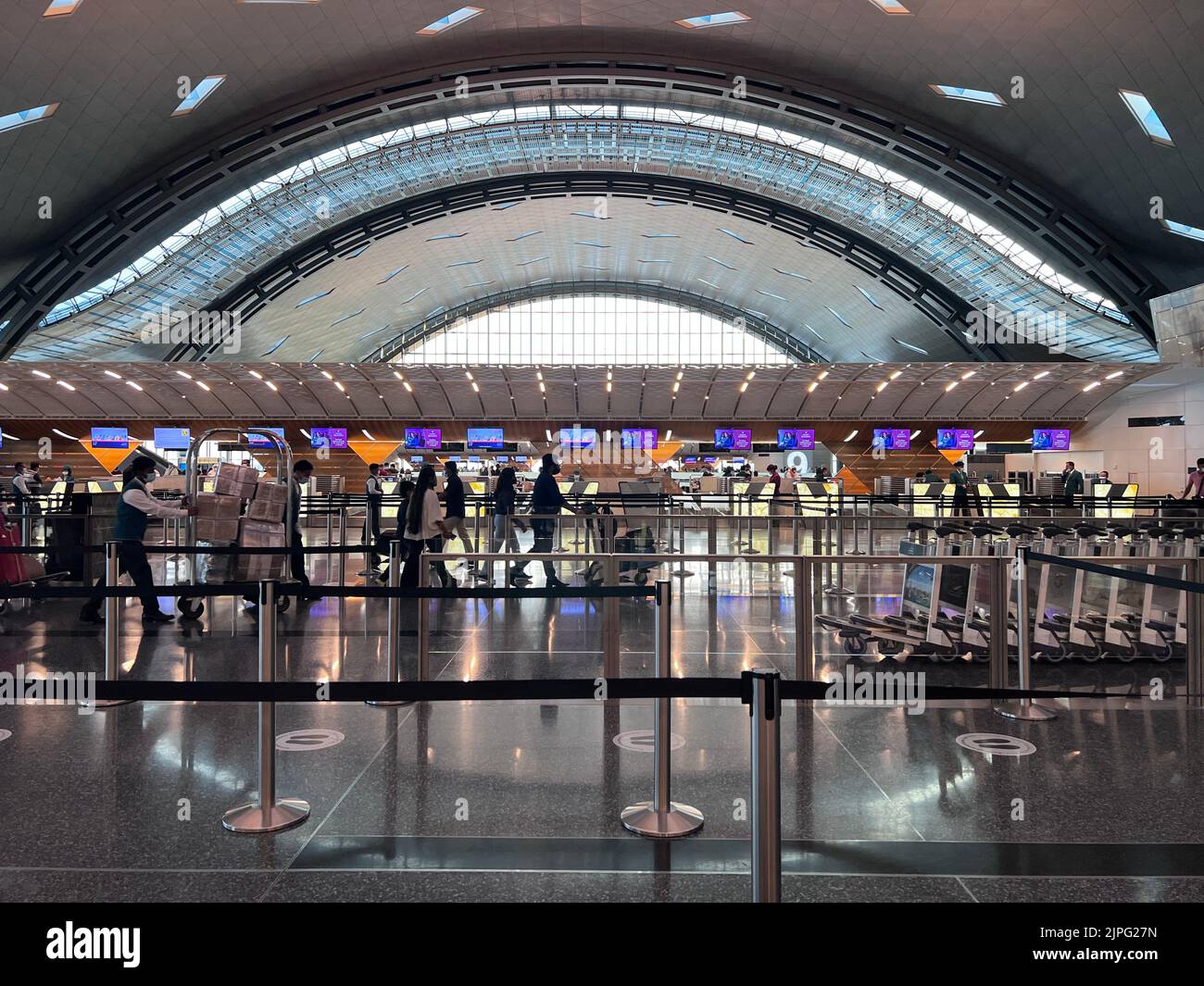 Interior of Hamad International Airport Terminal full of Tourist People ...