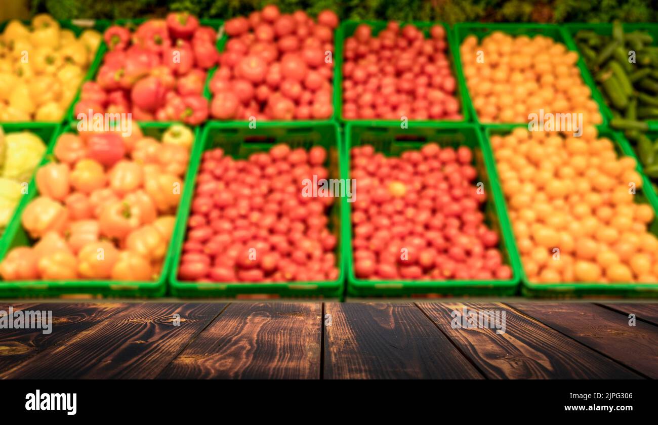 Supermarket table background. A counter with blurred vegetables and ...
