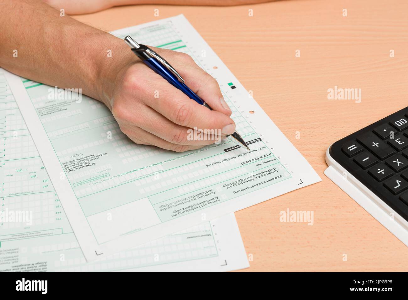 close-up of completing, processing, editing a tax declaration form ...