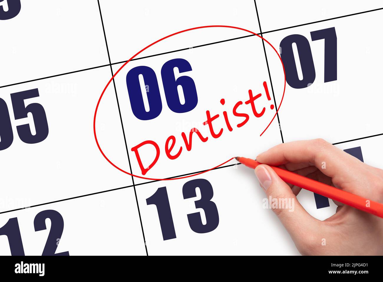 6th day of the month. Hand writing text DENTIST and circling the ...