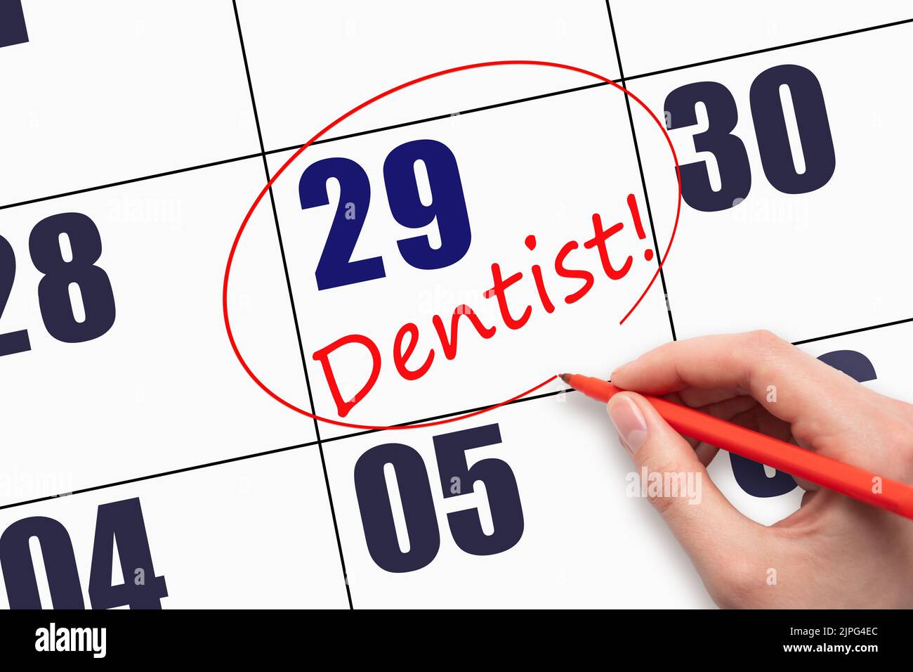 29th day of the month. Hand writing text DENTIST and circling the ...