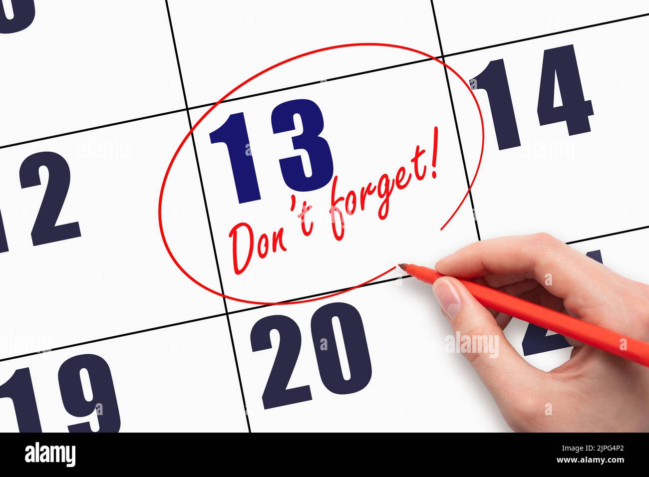 13th day of the month. Hand writing text DO NOT FORGET and circling the ...