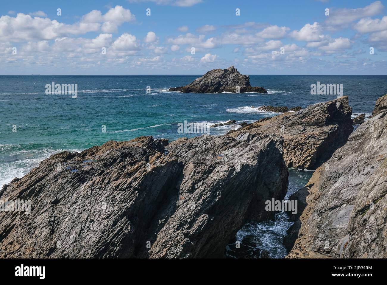 The rocky island The Goose off the rugged rocks on the coast of Pentire ...