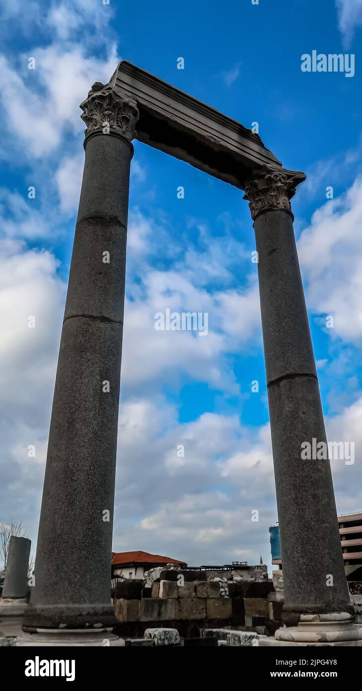 Profile view of two high columns stading inside the ancient city of ...