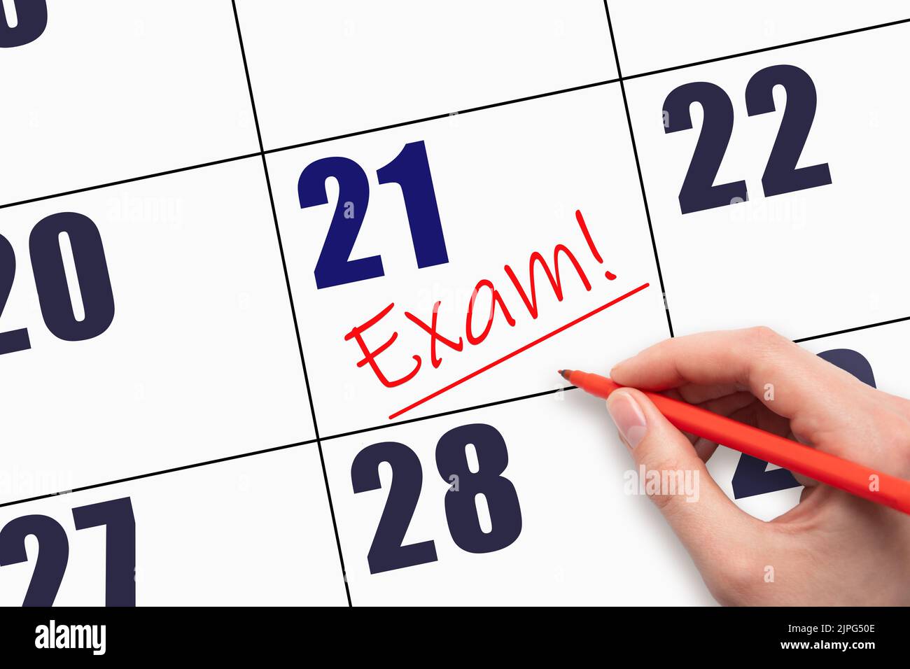 21st day of the month. Hand writing text EXAM and drawing a line on ...
