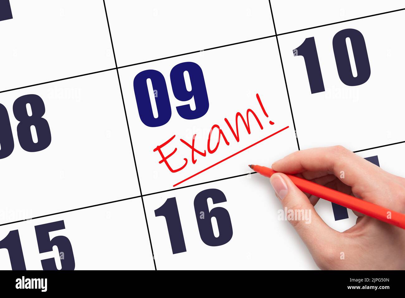 9th day of the month. Hand writing text EXAM and drawing a line on ...