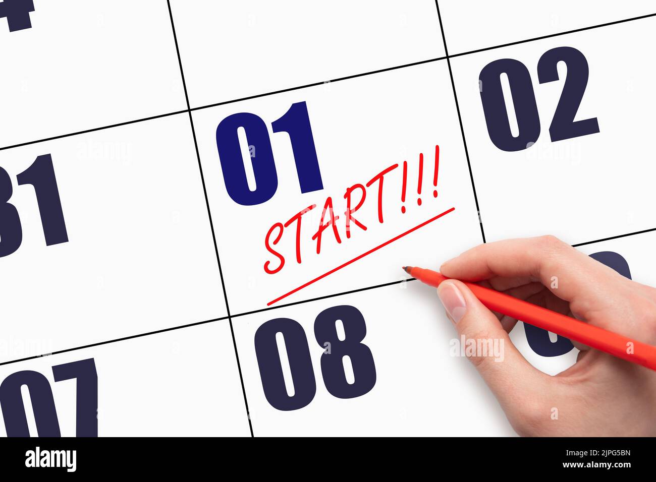 1st day of the month. Hand writing text START and drawing a line on ...