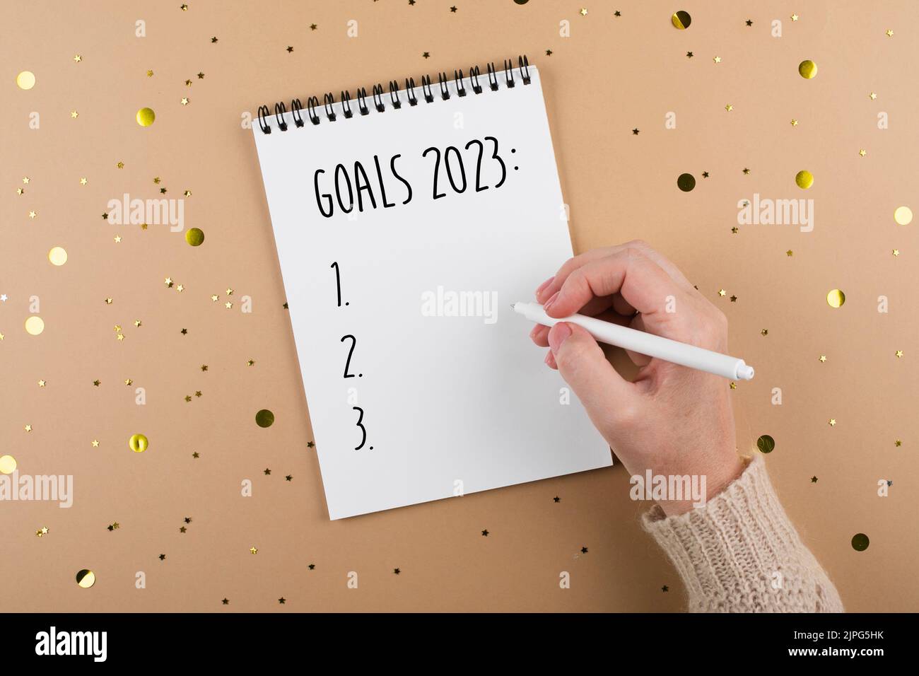 New Year goals 2023. Woman's hand writing in note pad goals list ...