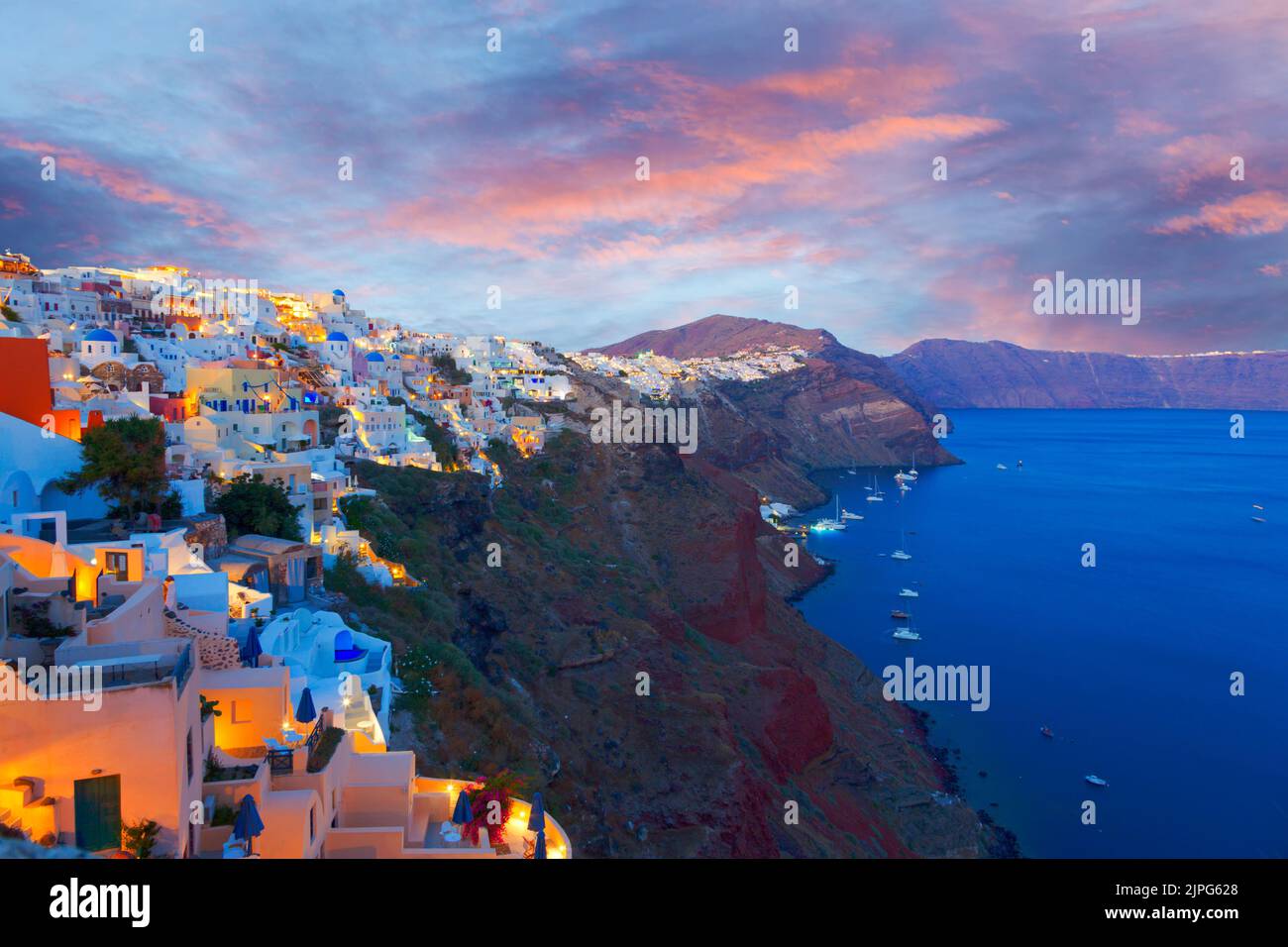 Santorini during sunset, view over traditional village Oia, Cyclades ...