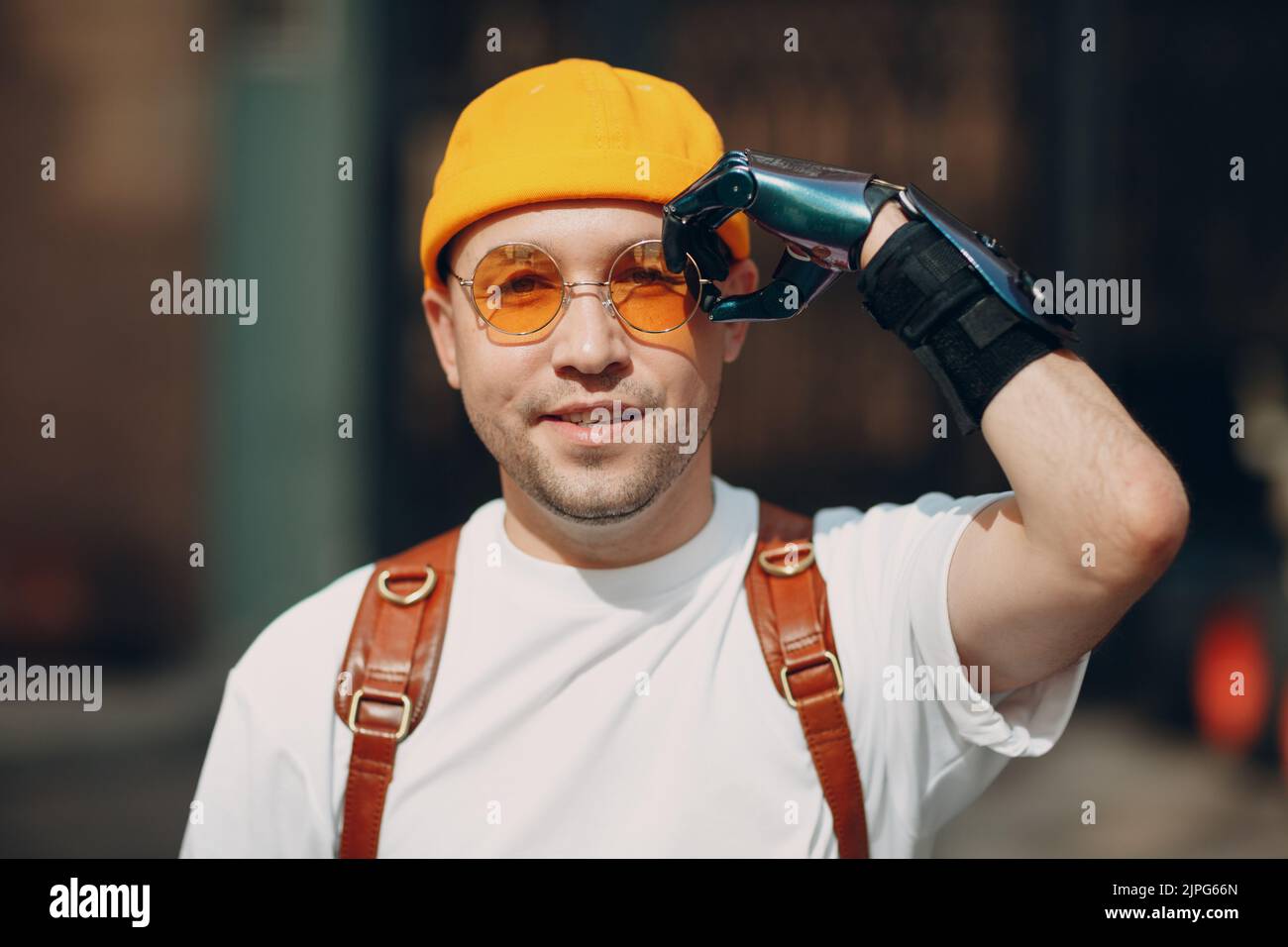Young disabled man portrait put on yellow glasses with artificial ...