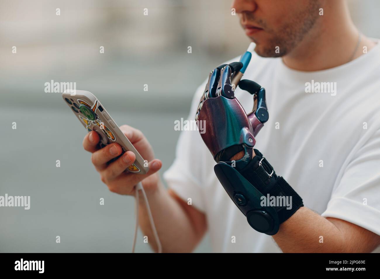 Young disabled man smoke electronic cigarette with artificial ...