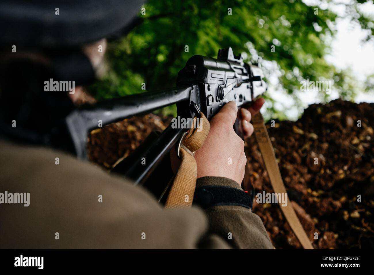 A soldier in a trench on the front line of the Ukrainian-Russian war ...