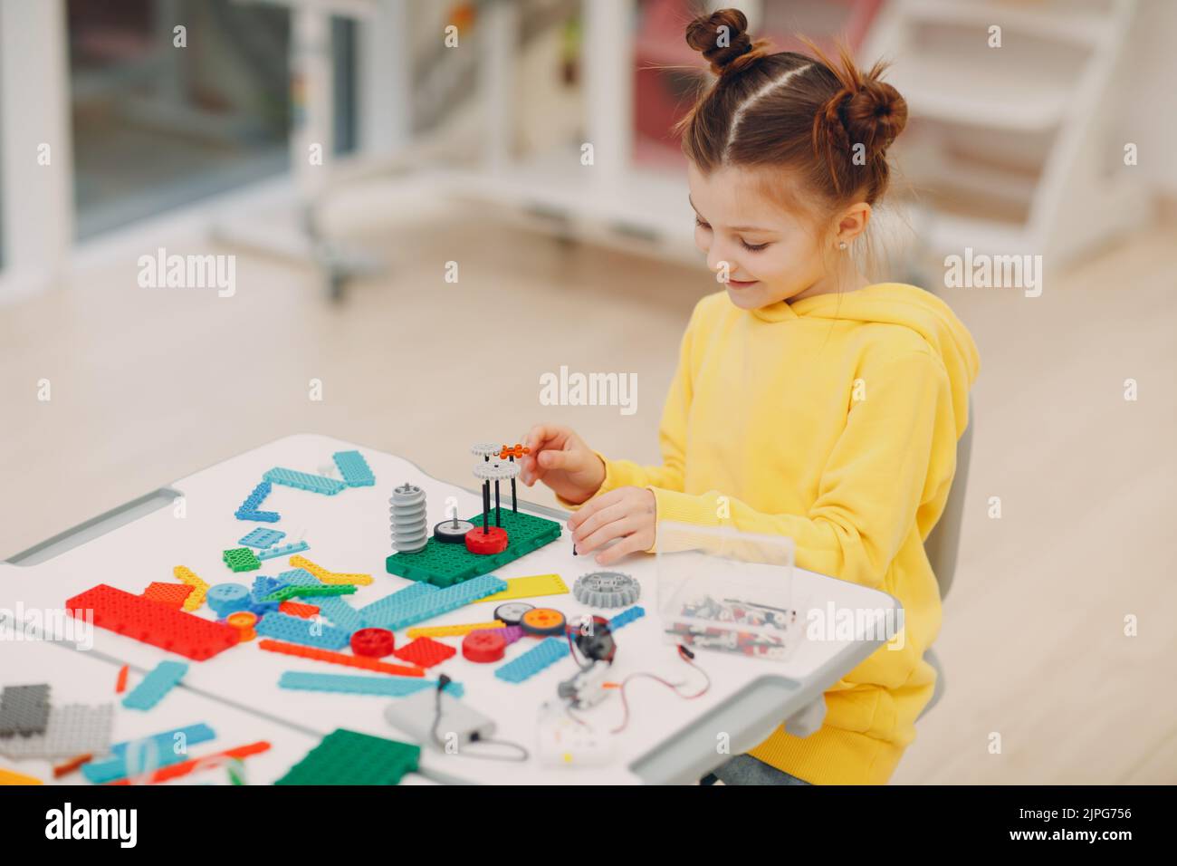 Little girl kid child constructor checking technical toy. Children ...