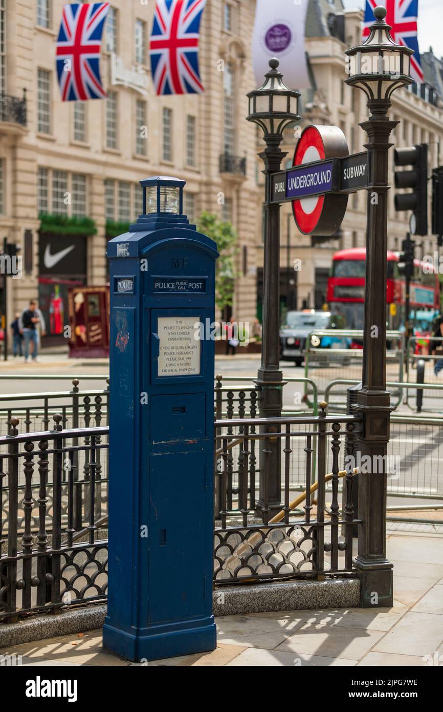 A police box with British flags and an underground sign in Picadilly ...